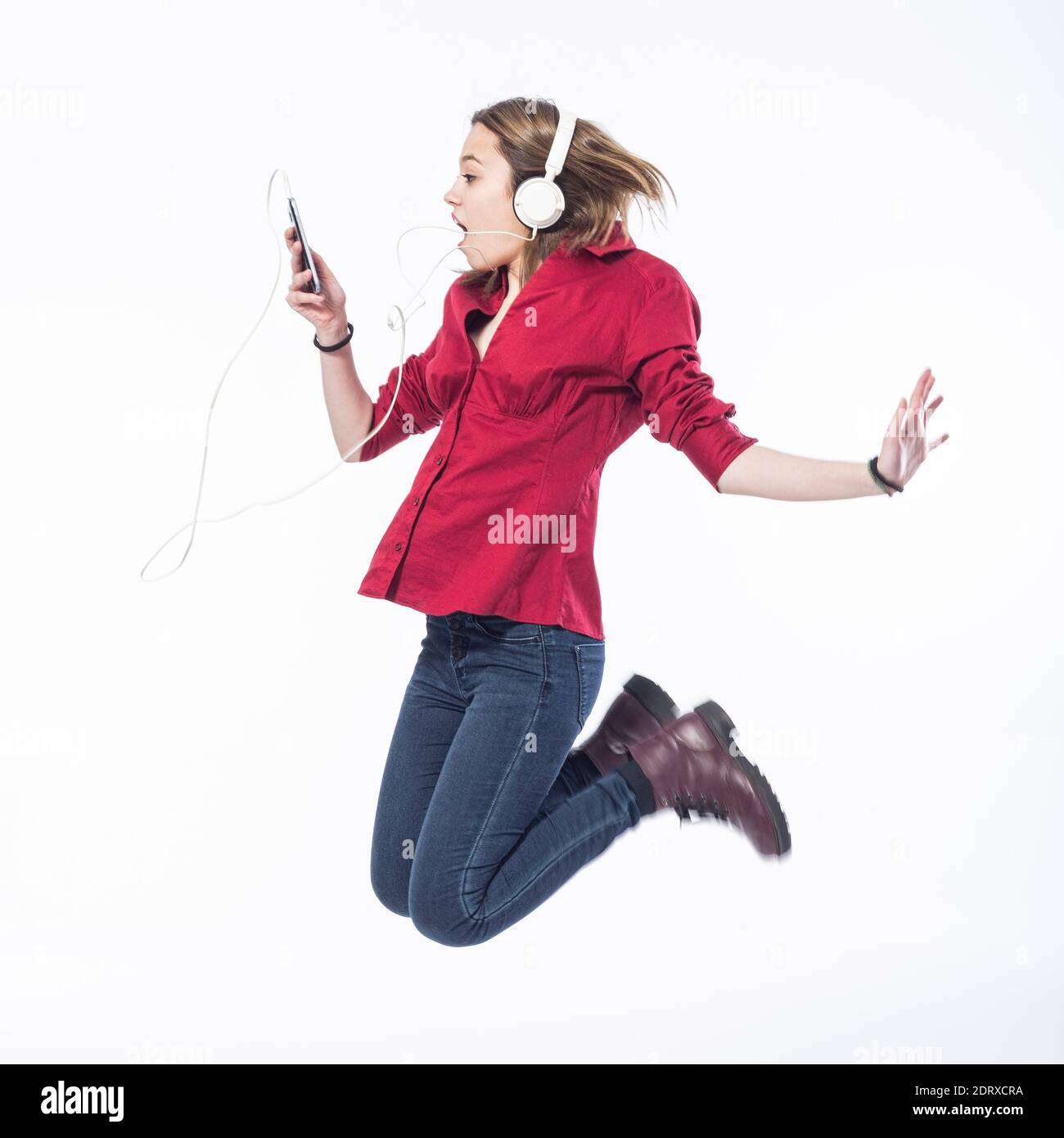 Happy girl junping over white background Stock Photo - Alamy