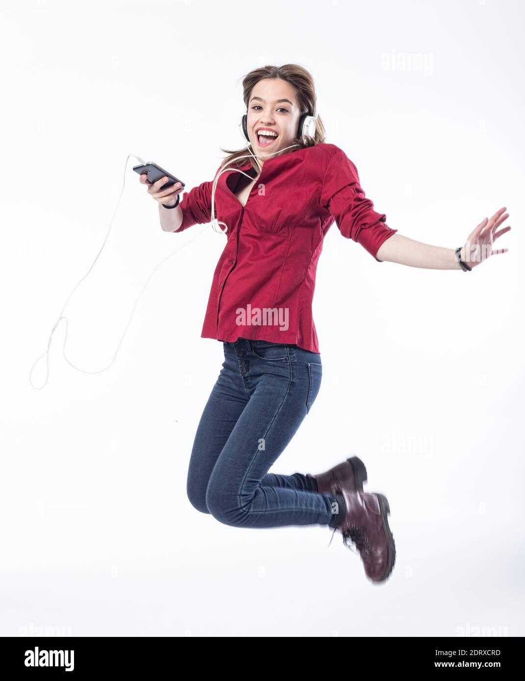 Happy girl junping over white background Stock Photo - Alamy