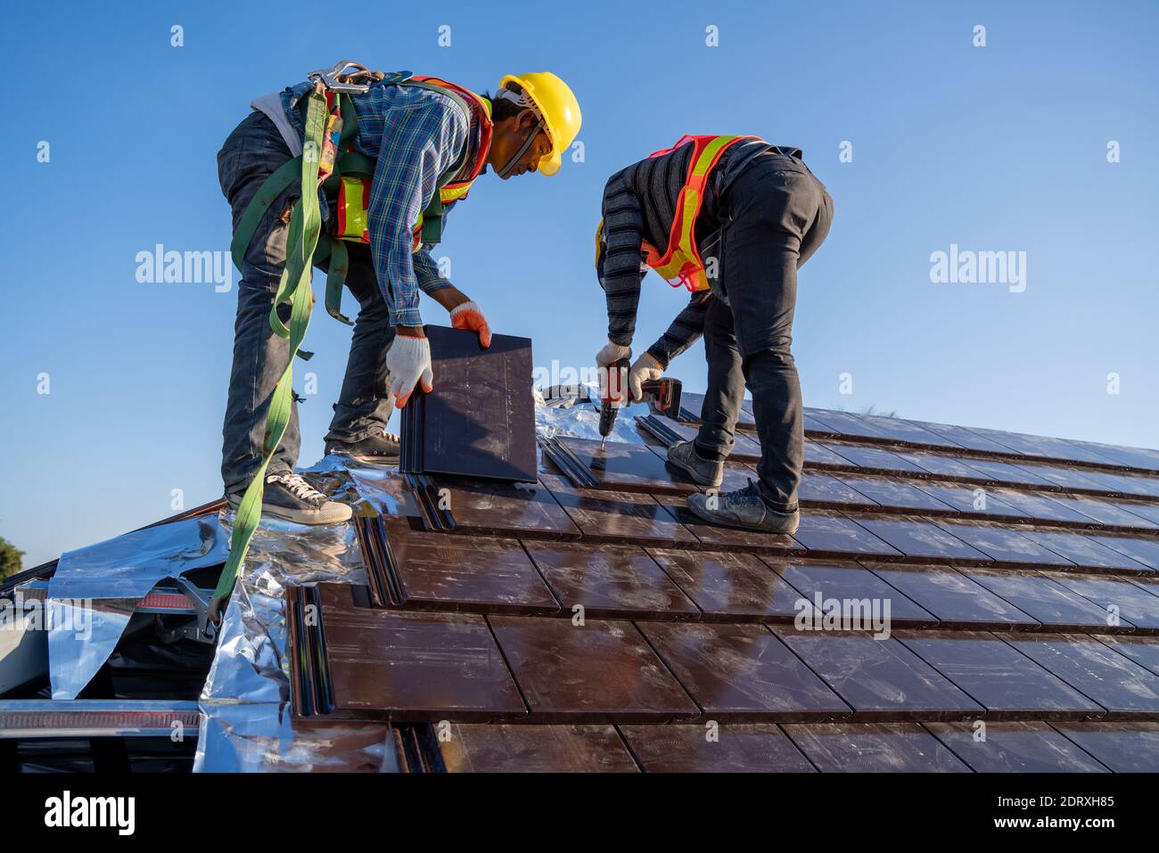 Team work construction worker install new ceramic tile roof in the ...