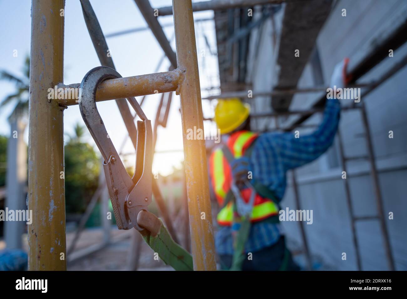 Construction worker wearing safety harness and safety line working at ...