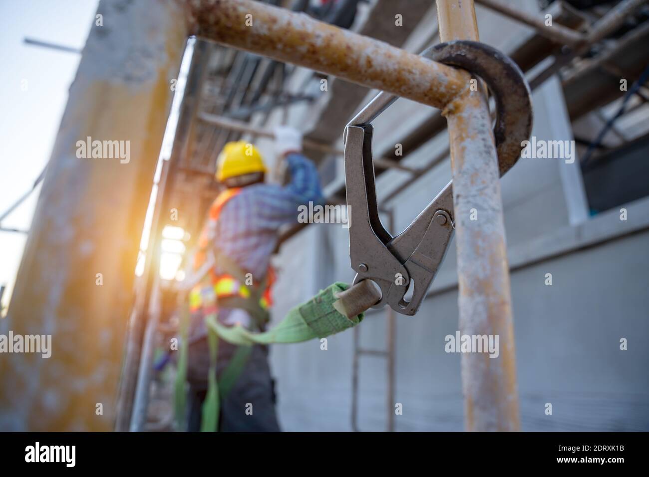 Construction worker wearing safety harness and safety line working at high place, Fall arrestor ...