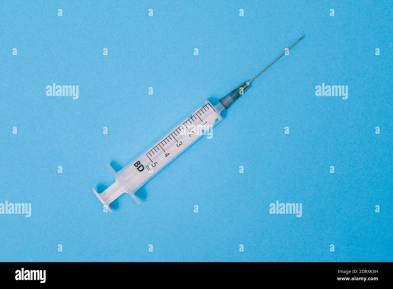 Medical syringe isolated on a blue background. Disposable plastic ...