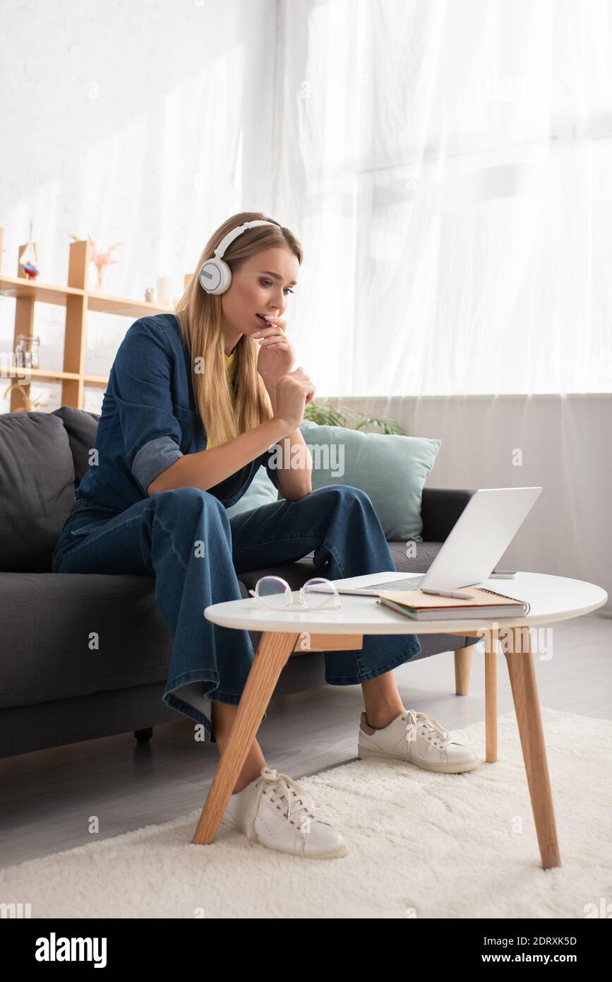 Scared woman in headphones hi-res stock photography and images - Alamy