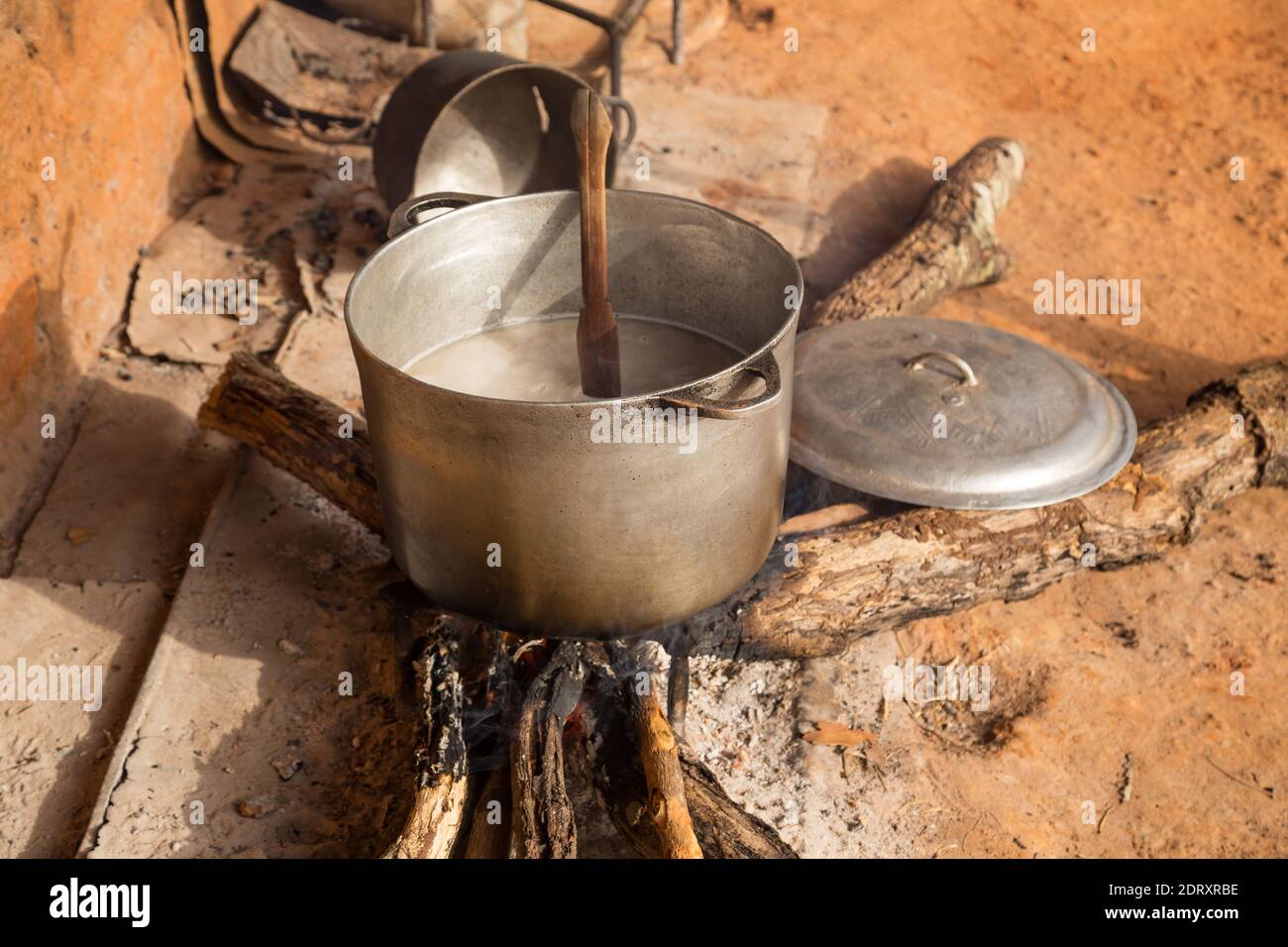 African outdoors kitchen firewood, big cast pots boiling in a village ...