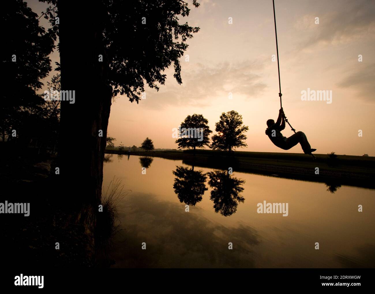 Rope swing over lake hi-res stock photography and images - Alamy