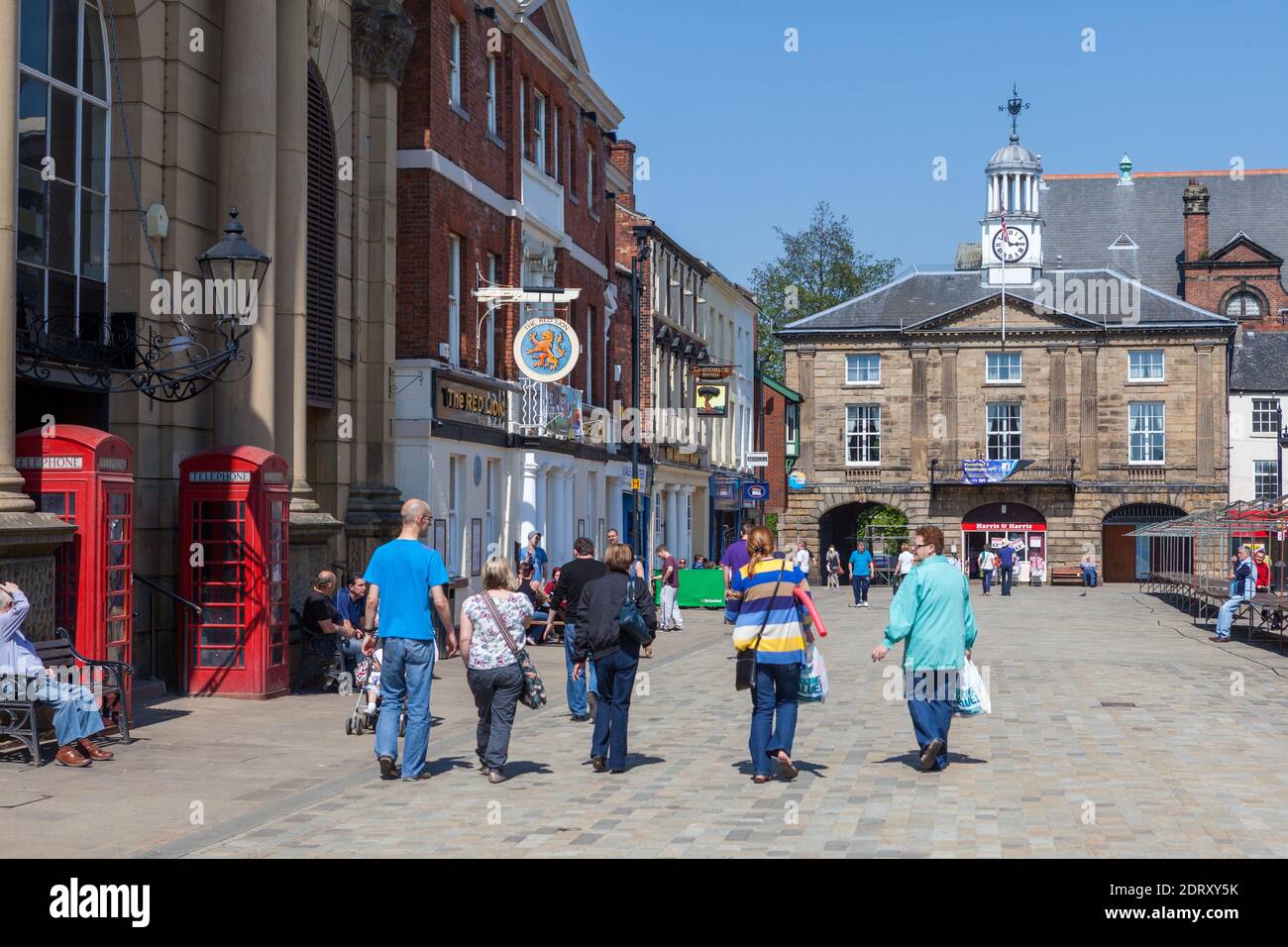 Shoppers walking along Pontefract Market Place on a sunny Summer day ...