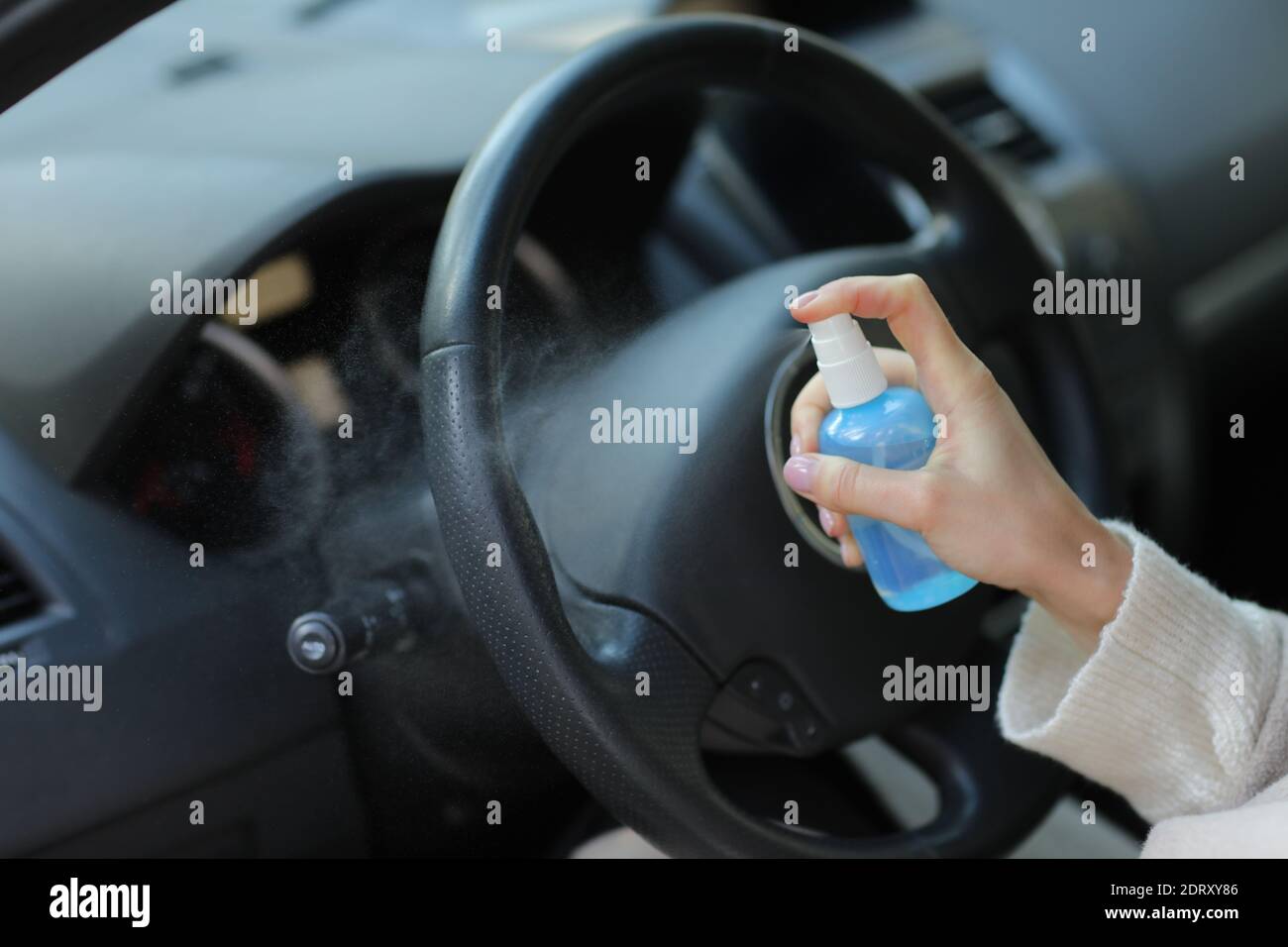 Hand of woman is spraying alcohol,disinfectant spray in car,safety ...
