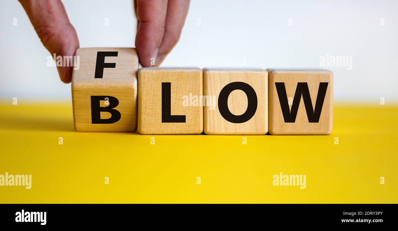 Blow or flow symbol. Male hand turns a cube and changes the word 'blow ...