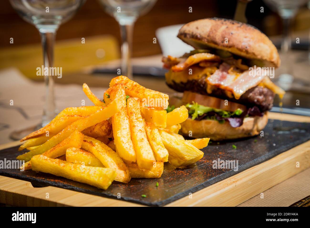 Traditional plate of chips and burger with glass on rustic table Stock ...