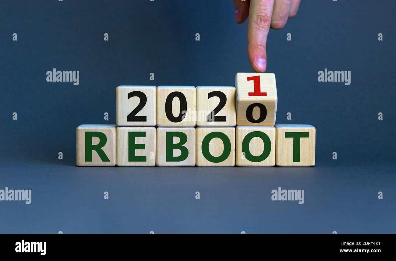 2021 reboot new year symbol. Male hand flips wooden cube and change the ...