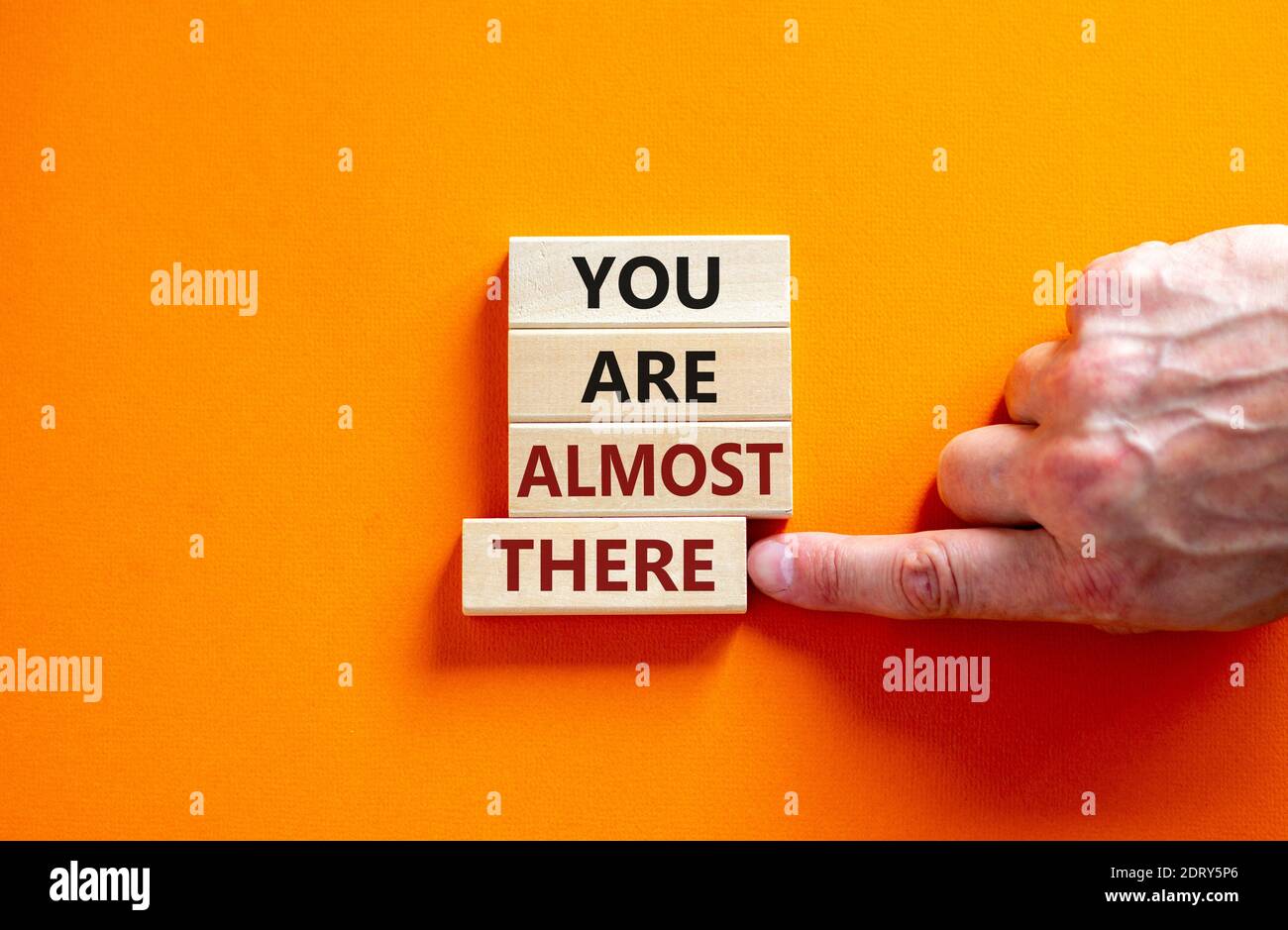 You are almost there symbol. Wooden blocks form the words 'You are ...