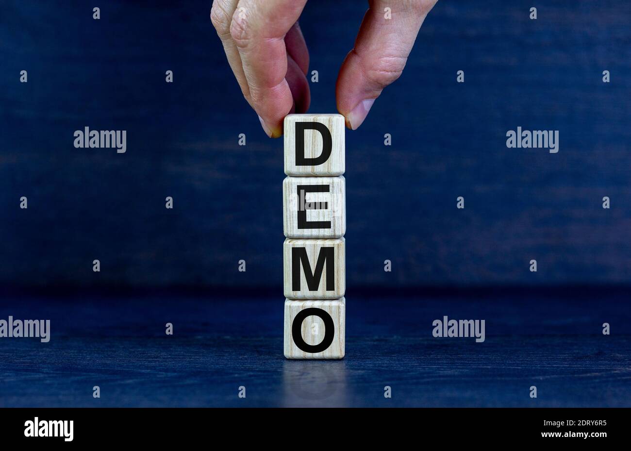 Demo symbol. Concept word 'demo' on cubes on a beautiful dark wooden ...