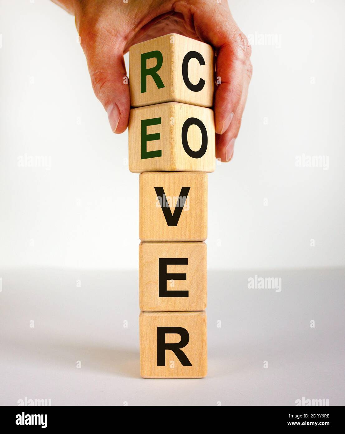 Time to recover symbol. The word 'recover' on wooden cubes. Male hand ...