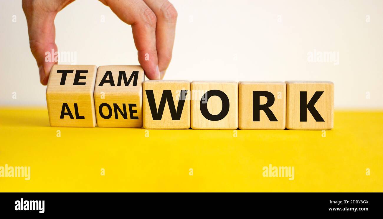 Alone or teamwork. Male hand flips wooden cubes and changes words ...