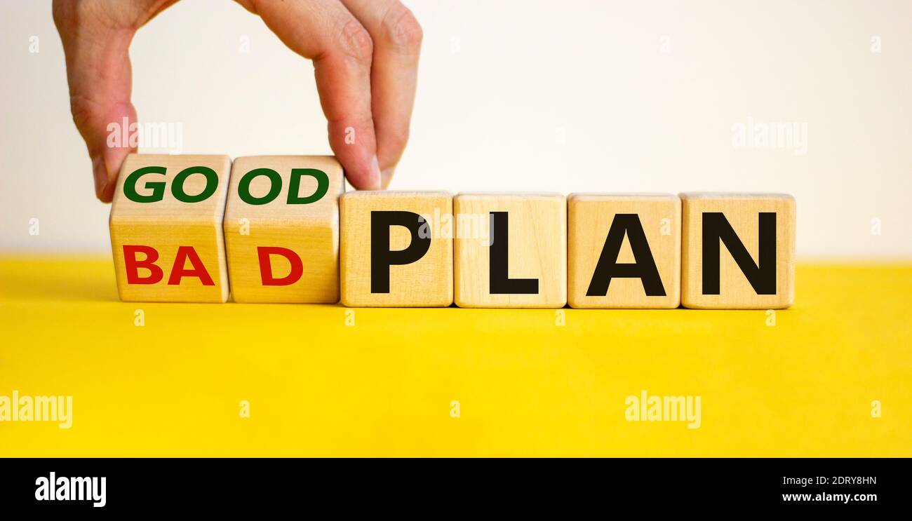Good a bad plan symbol. Male hand flips wooden cubes and changes words ...