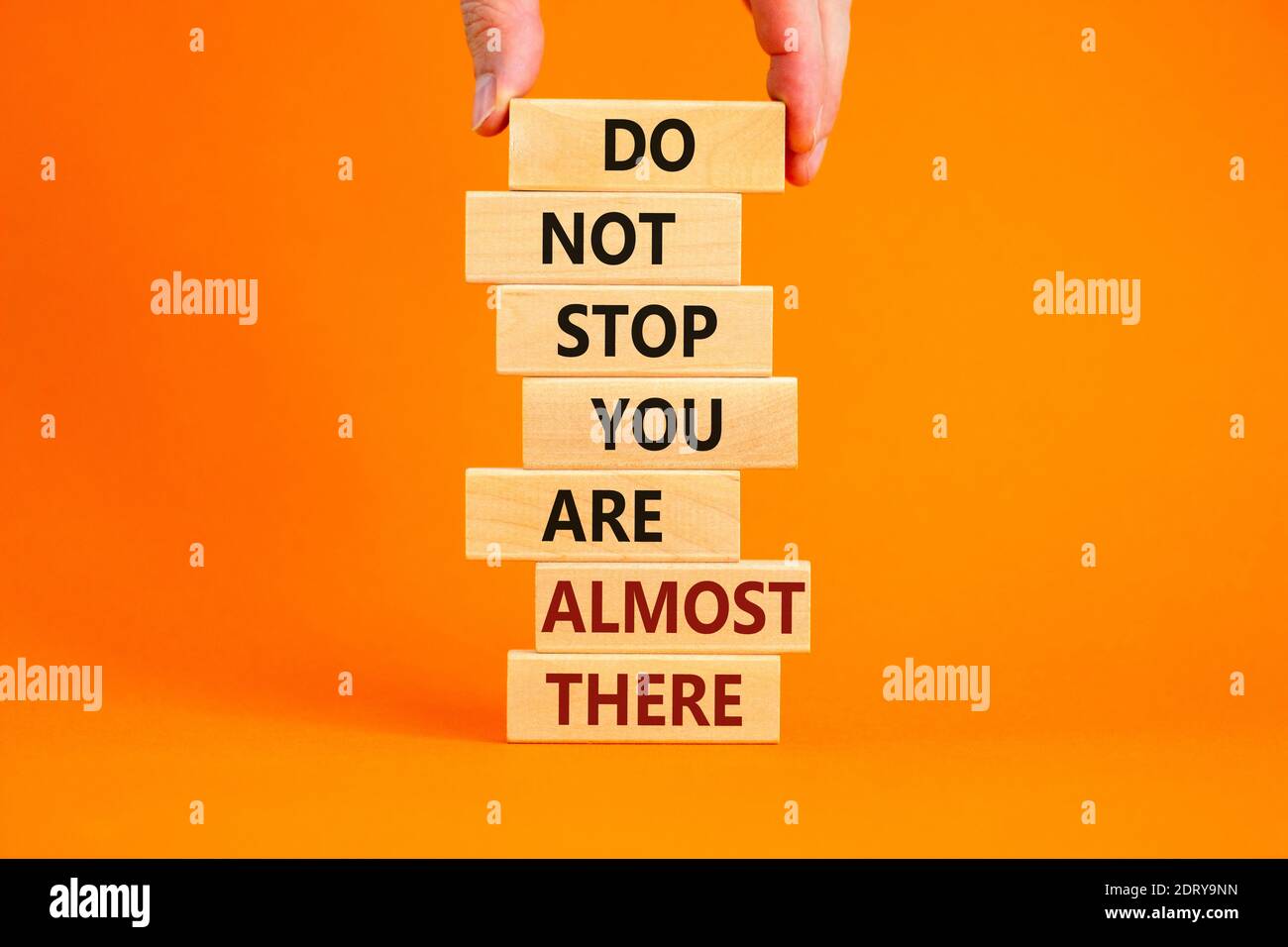 You are almost there symbol. Wooden blocks with words 'do not stop you ...