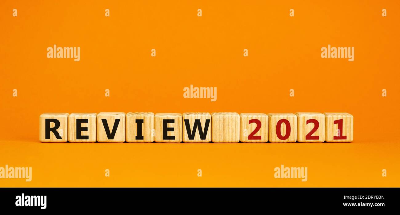 Symbol of starting 2021. Wooden cube with words 'Review 2021 ...