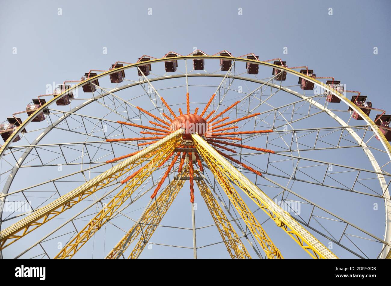 Yellow ferris wheel in an amusement park Stock Photo - Alamy