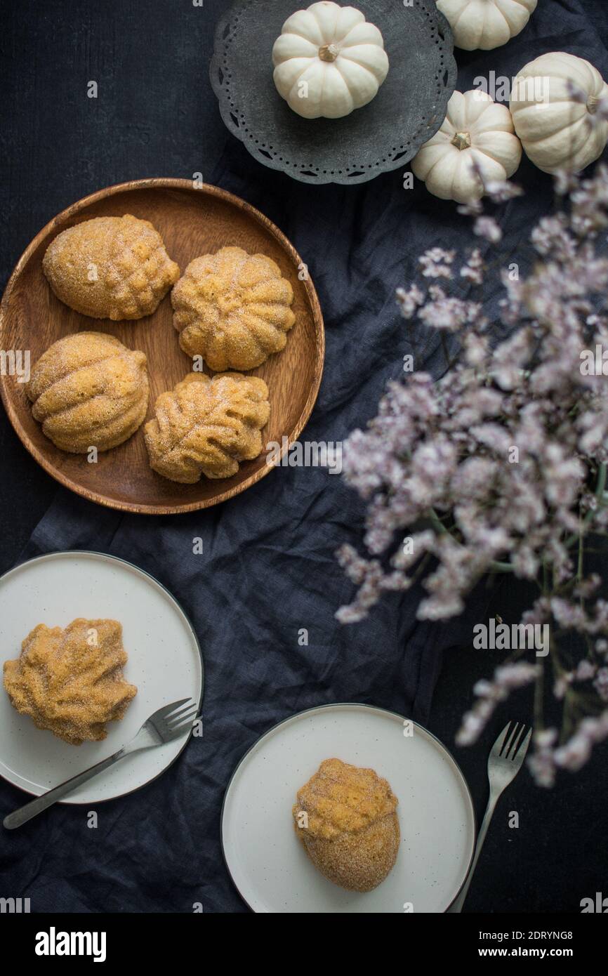 A top view of a dessert table with biscuits in the shape of leave and ...