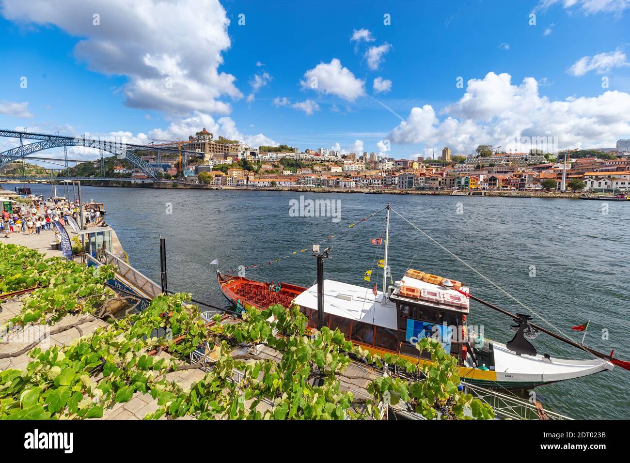 People enjoy the sunny and warm on the riverside quay of Porto. Porto ...