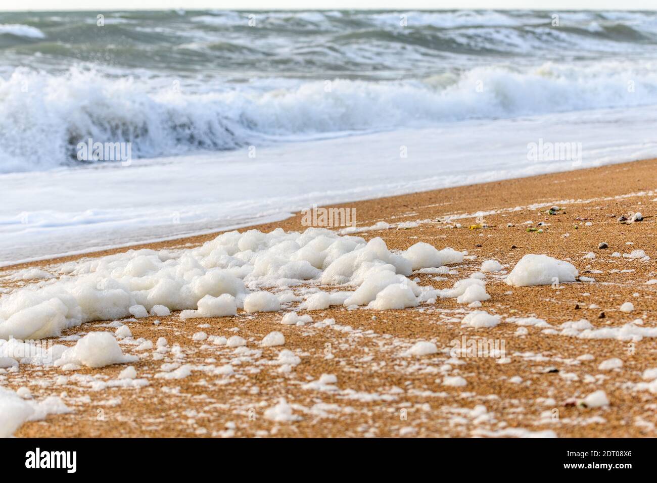 Windswept sea foam on a beach in the Atlantic Ocean near Olonne sur mer ...