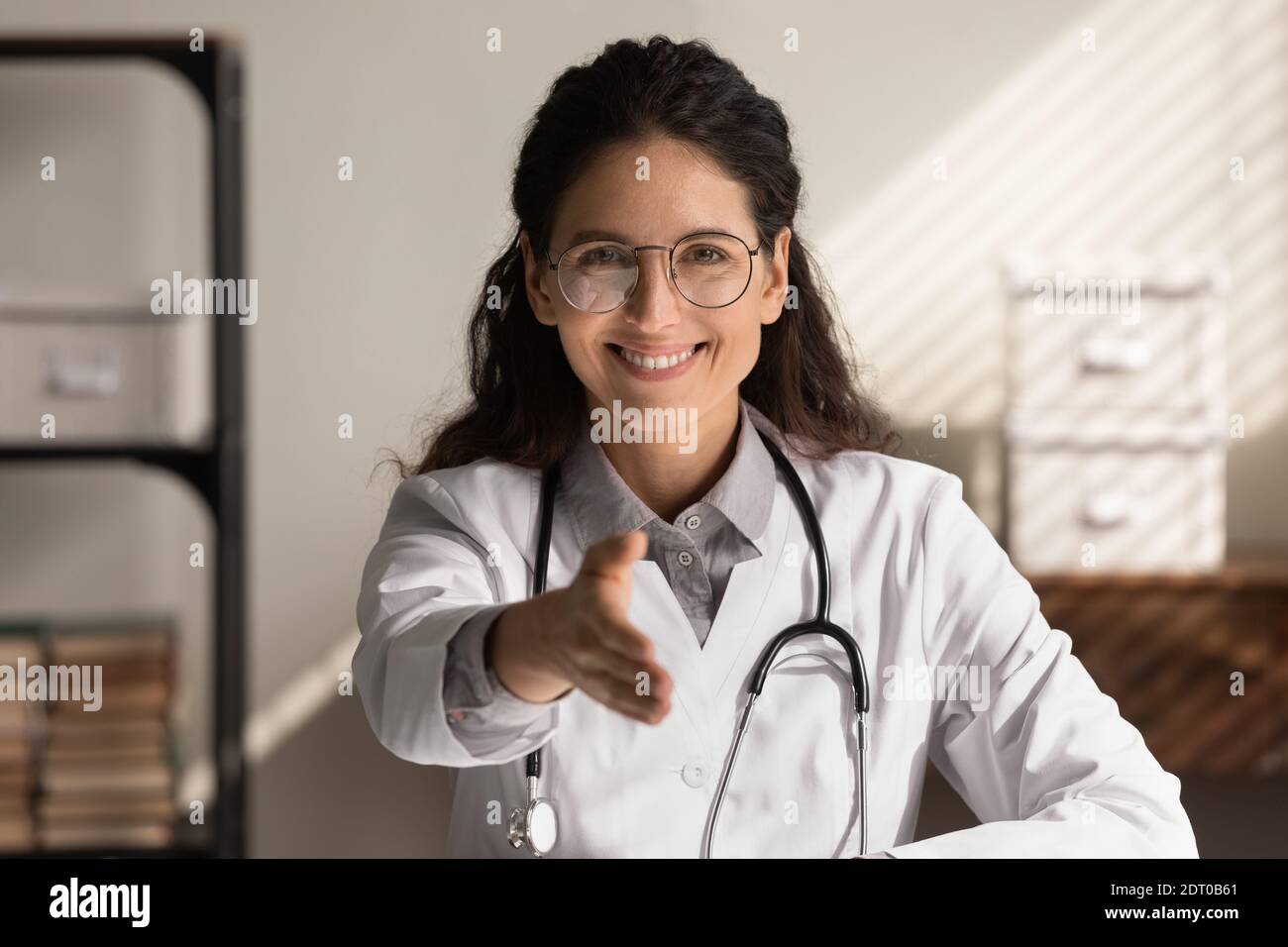 Portrait of smiling female doctor stretch hand greeting Stock Photo - Alamy