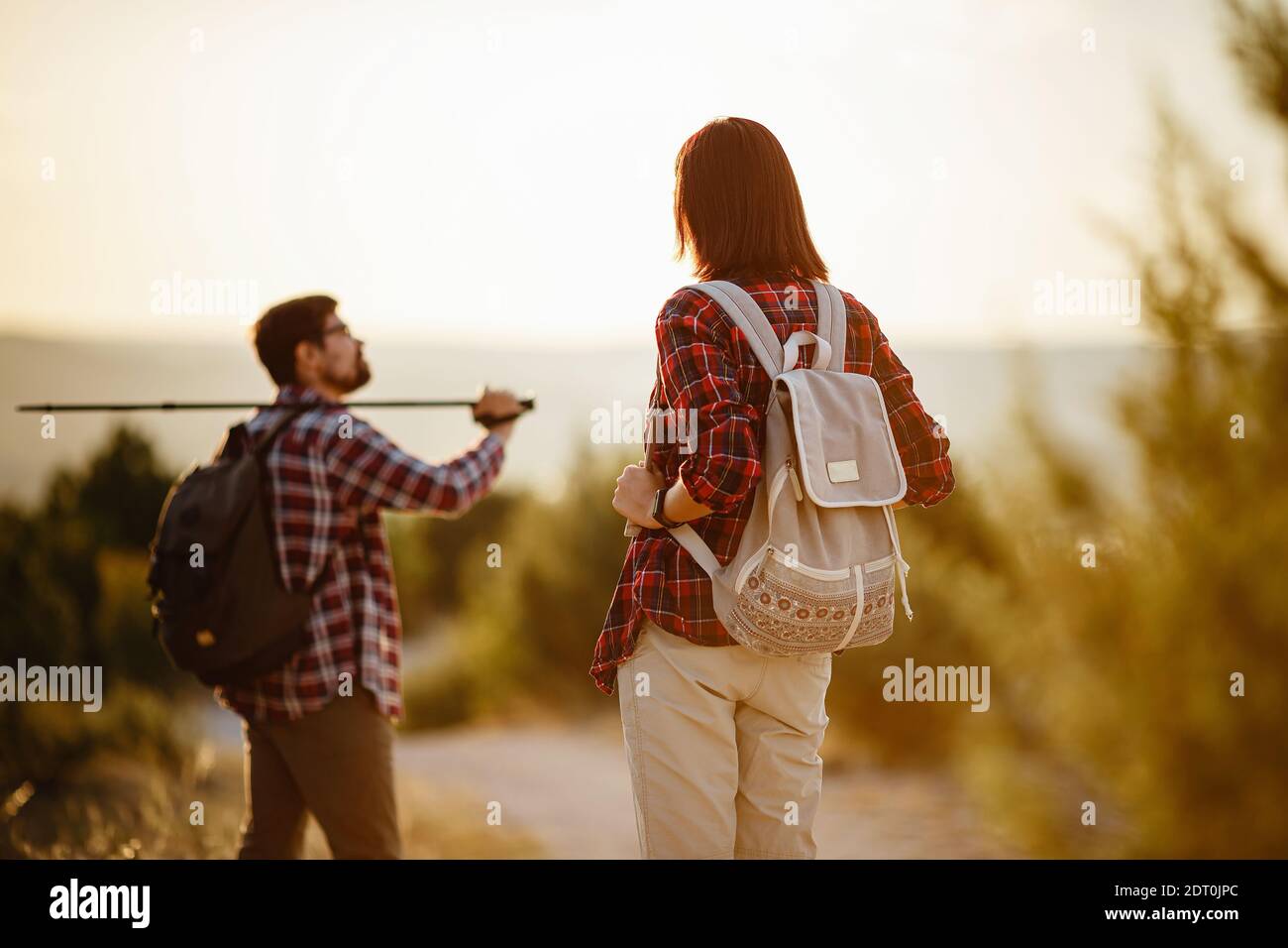 Portrait of happy young couple having fun on their hiking trip ...