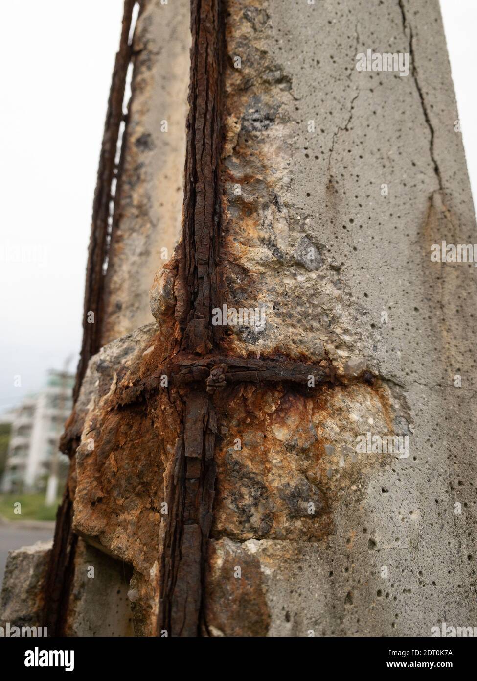 A vertical shot of rusted metal on the body of a transmission tower ...