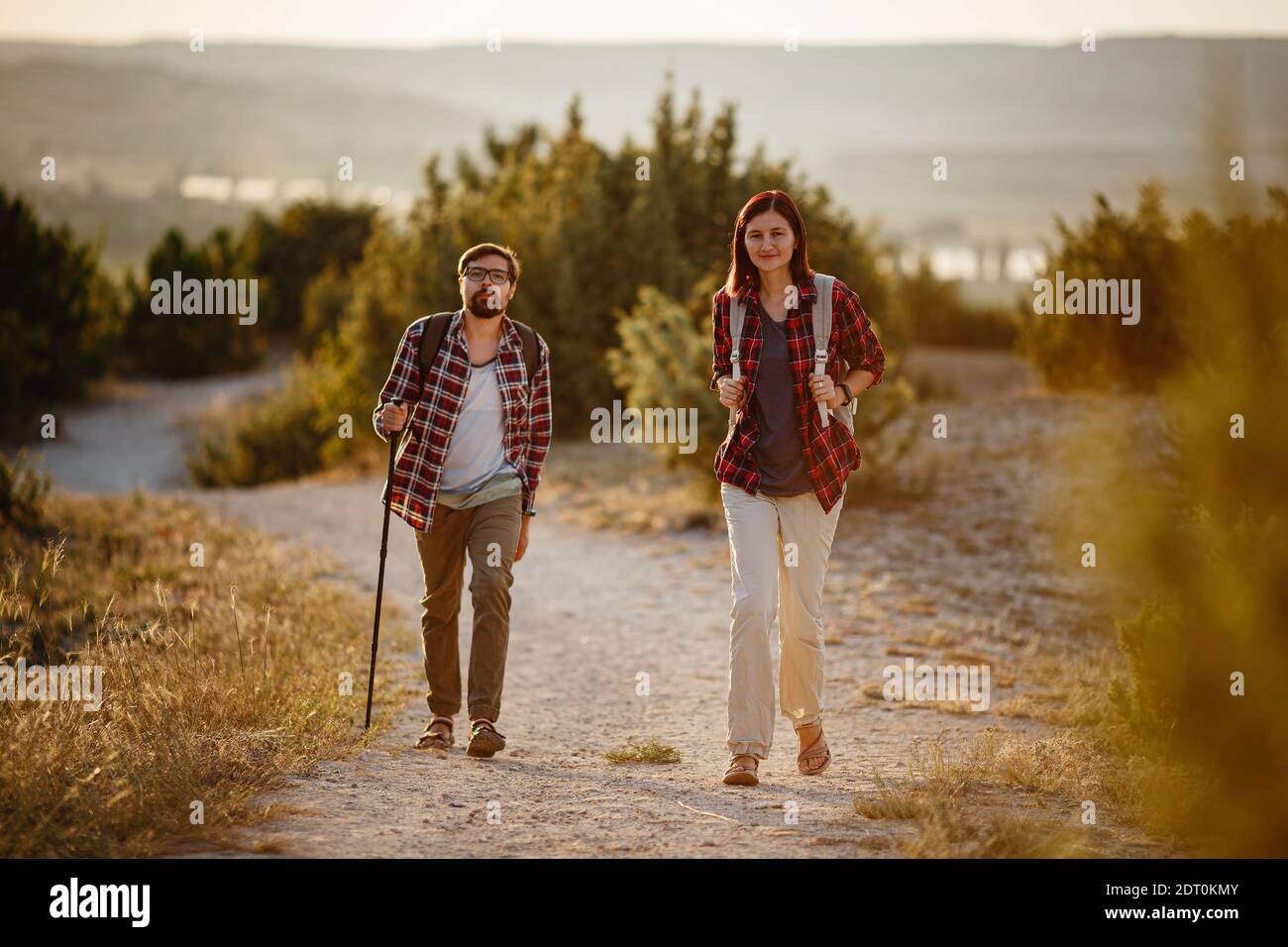 Portrait of happy young couple having fun on their hiking trip ...