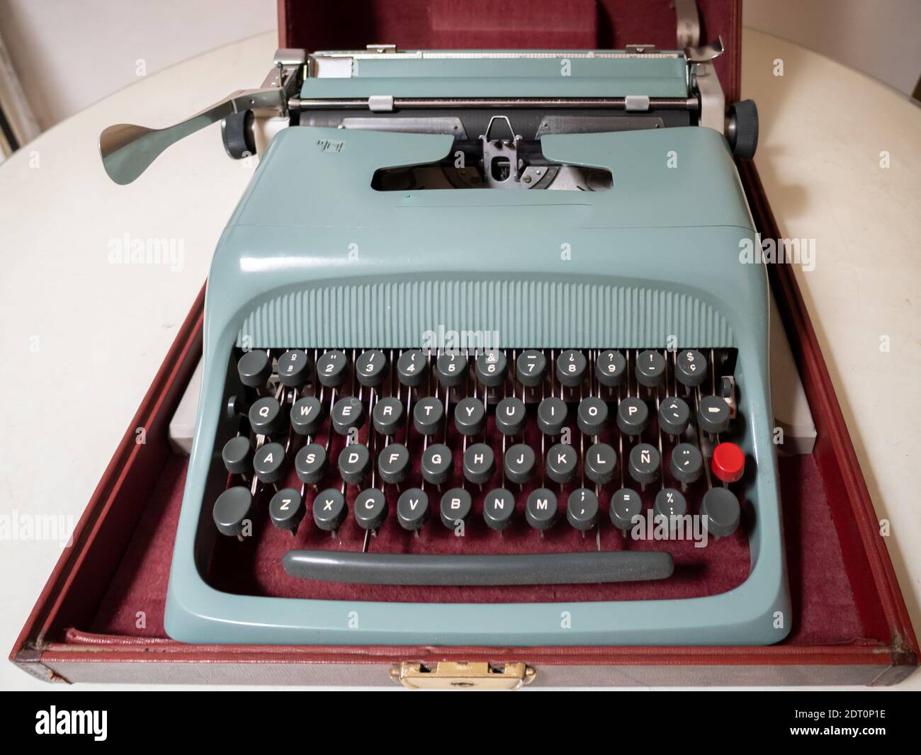 An old blue typing machine in a red box Stock Photo - Alamy