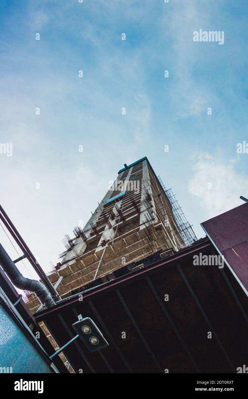 A low angle shot of a newly constructed commercial building with thin ...