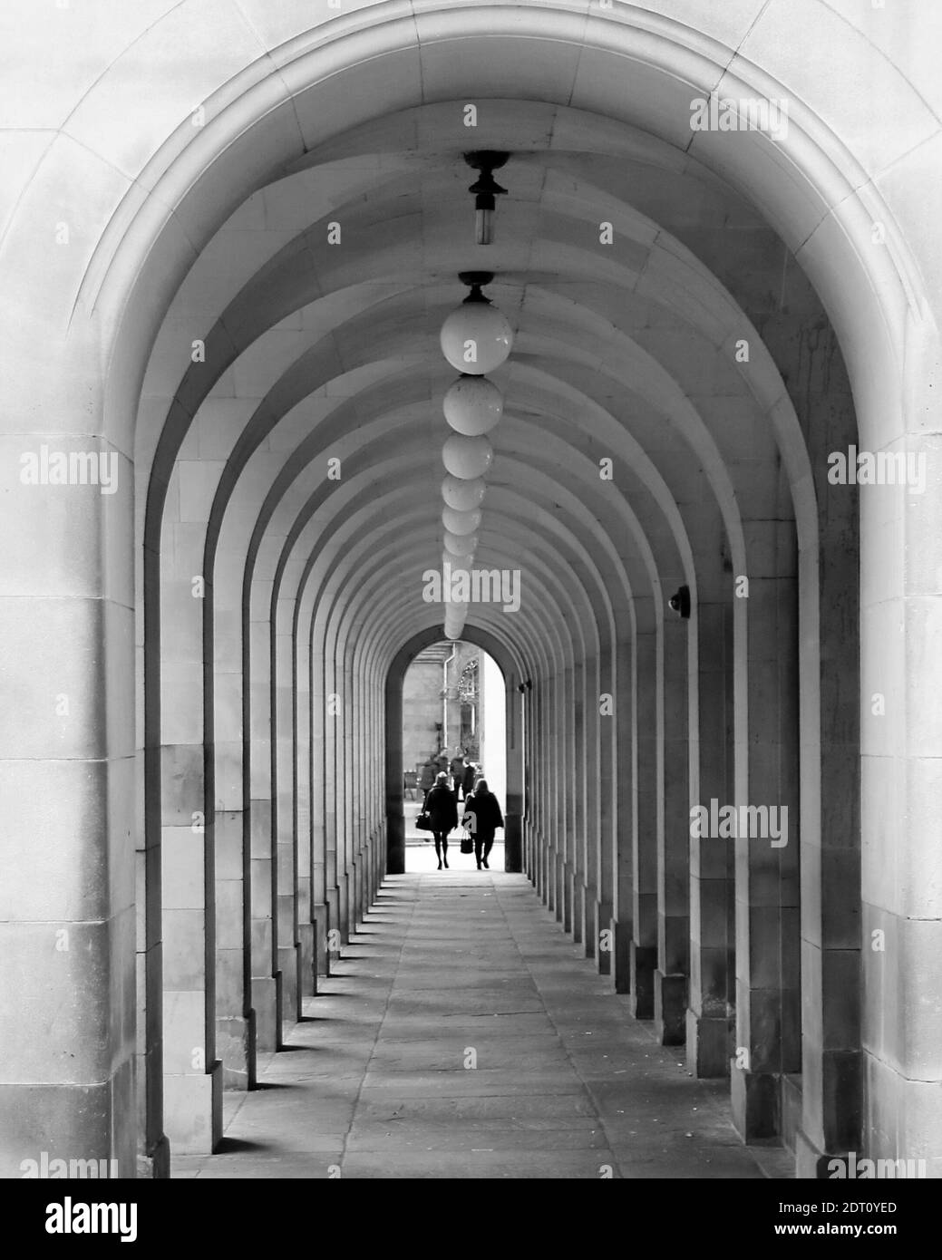 Rear View Of People Walking In Corridor Of Building Stock Photo - Alamy