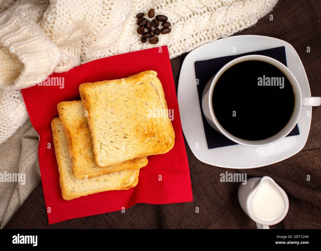 Breakfast coffee with milk and crispy toast. Black coffee with milk and ...