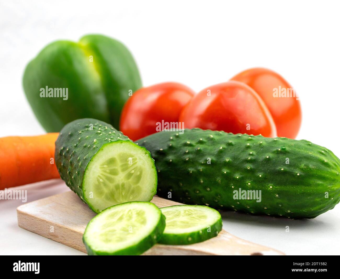Fresh cucumber is cut into rings. Fresh vegetables on a white ...