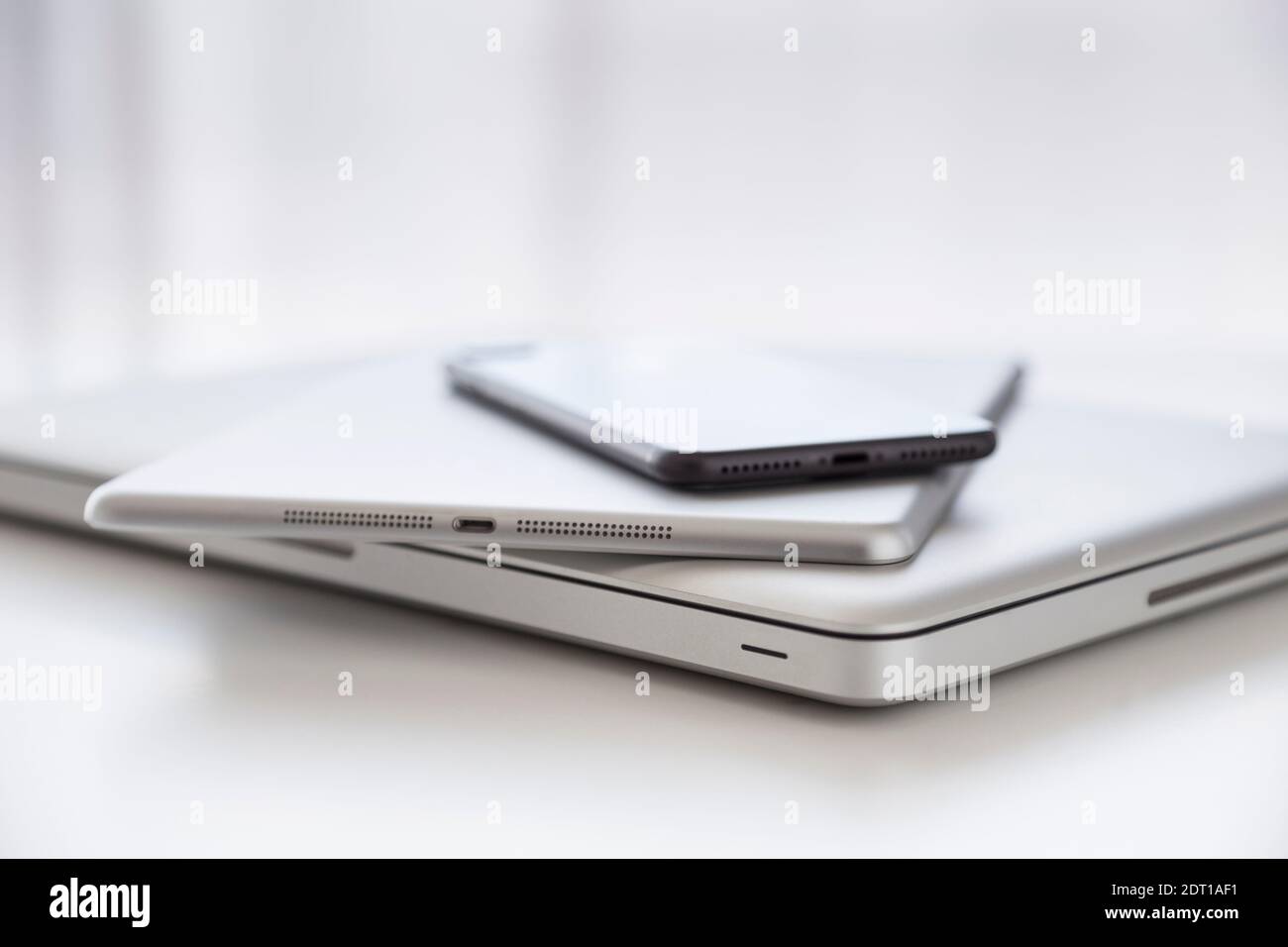 Set of a computer, a tablet and a smatphone against white desk Stock ...