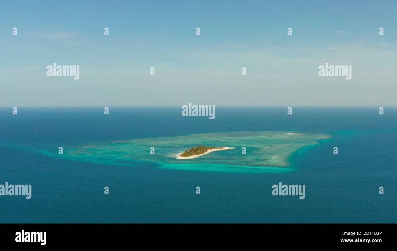 Small tropical island in the blue sea with a coral reef and the beach ...