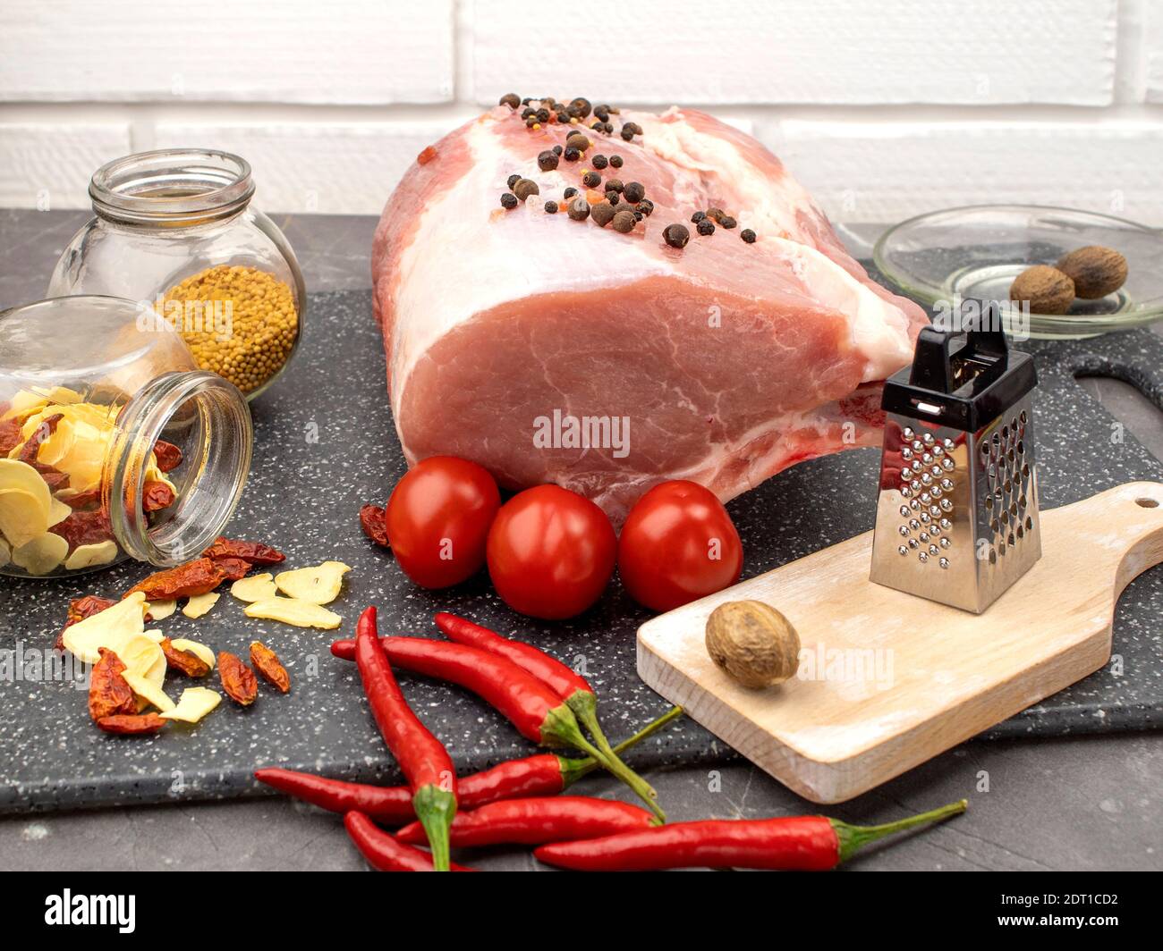 Raw pork meat on a marble board with spices and vegetables Stock Photo ...