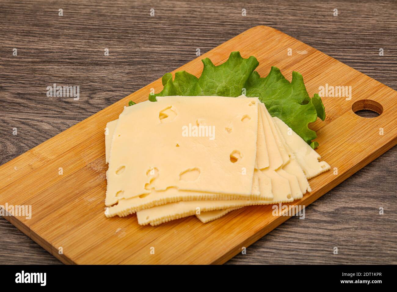 Sliced yellow cheese over salad leaves Stock Photo - Alamy