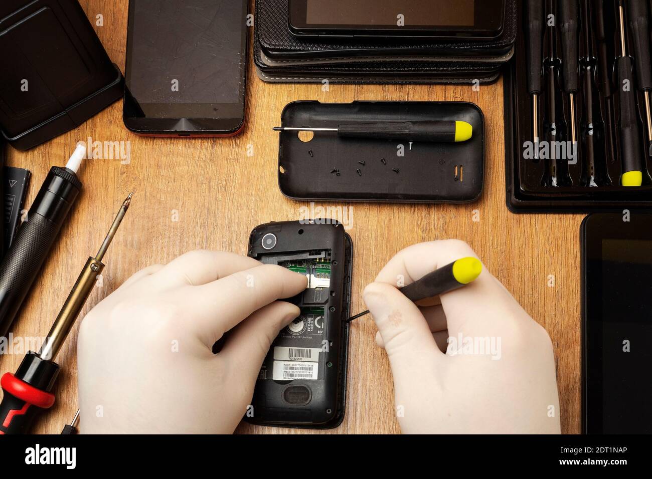 Dismantling an old phone for repair on a table Stock Photo - Alamy