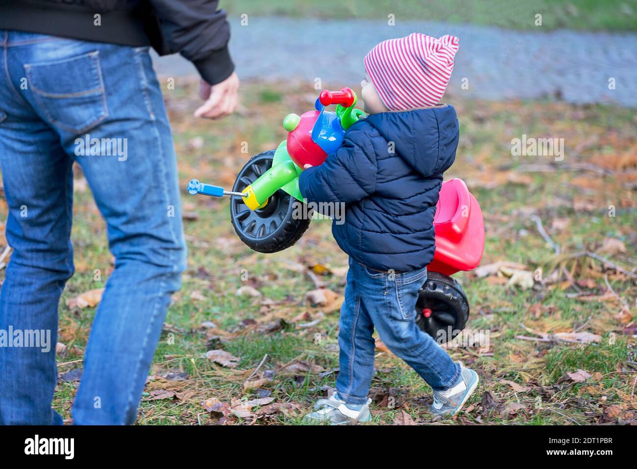Standing holding childhood tricycle hi-res stock photography and images ...