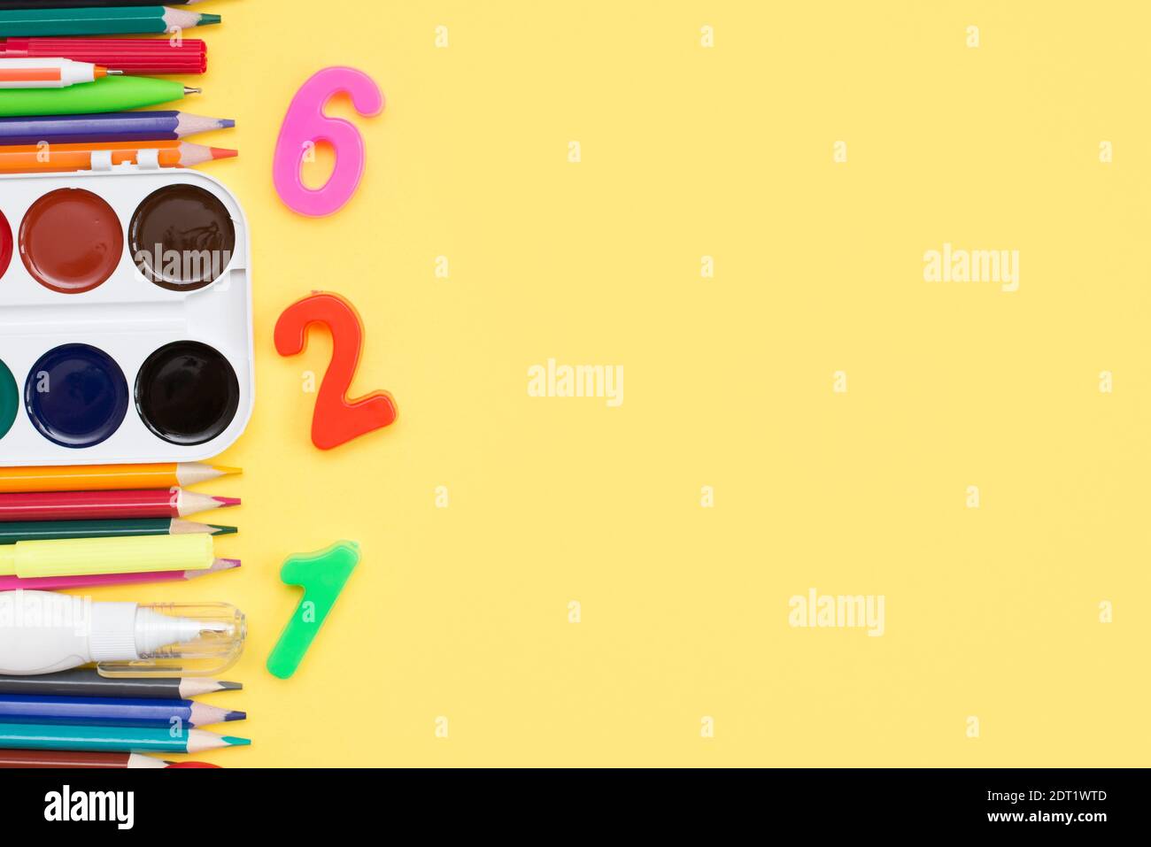Stationery for kids and colorful numbers on yellow background with a ...