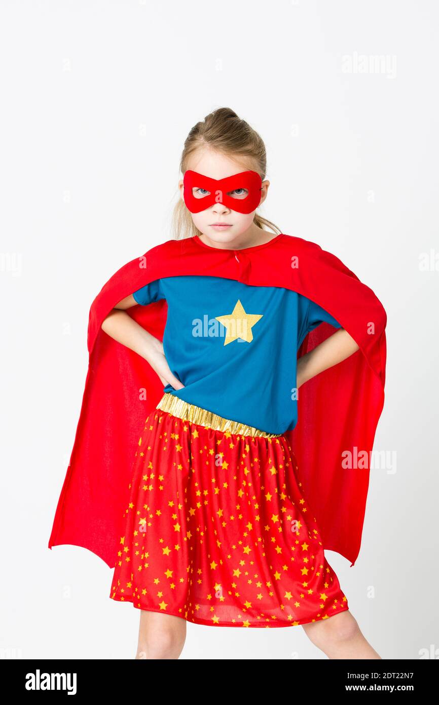 Portrait Of Girl In Superhero Costume Standing Against White Background ...