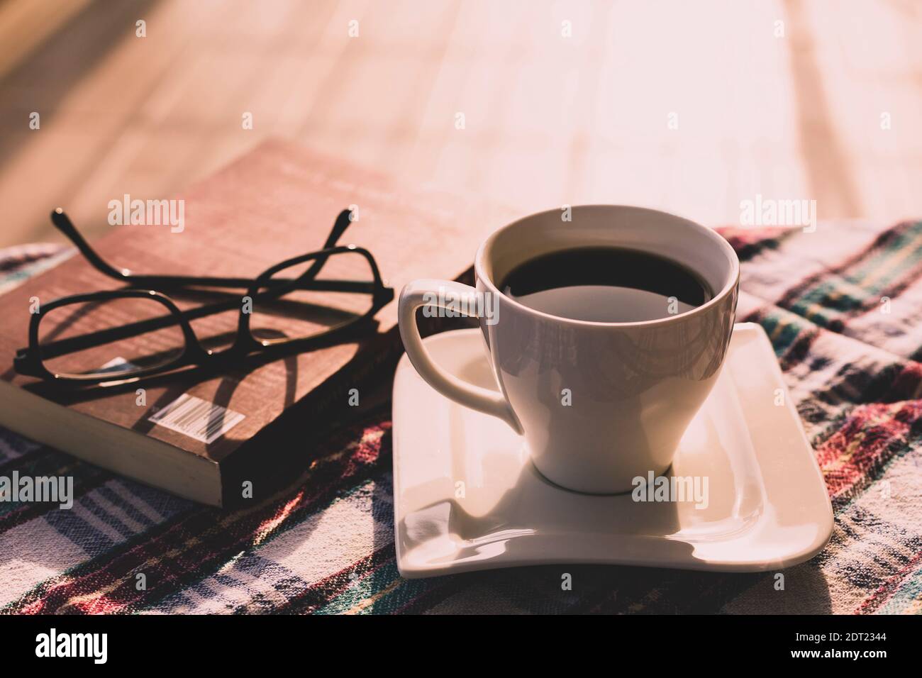 Tea and book reading time, glasses on the book in house Stock Photo - Alamy