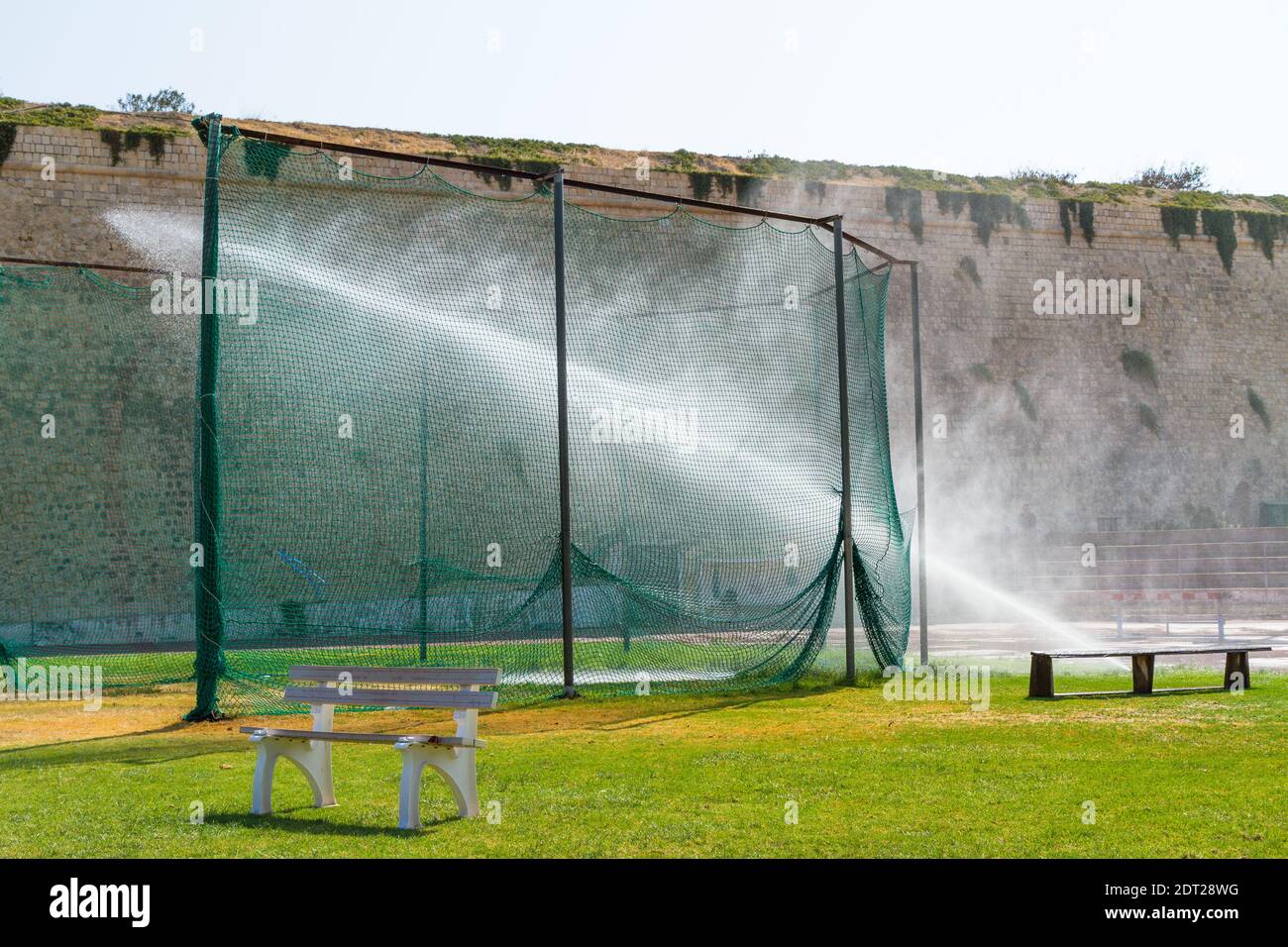 Sprinkler watering the grass of a local sports training stadium Stock ...