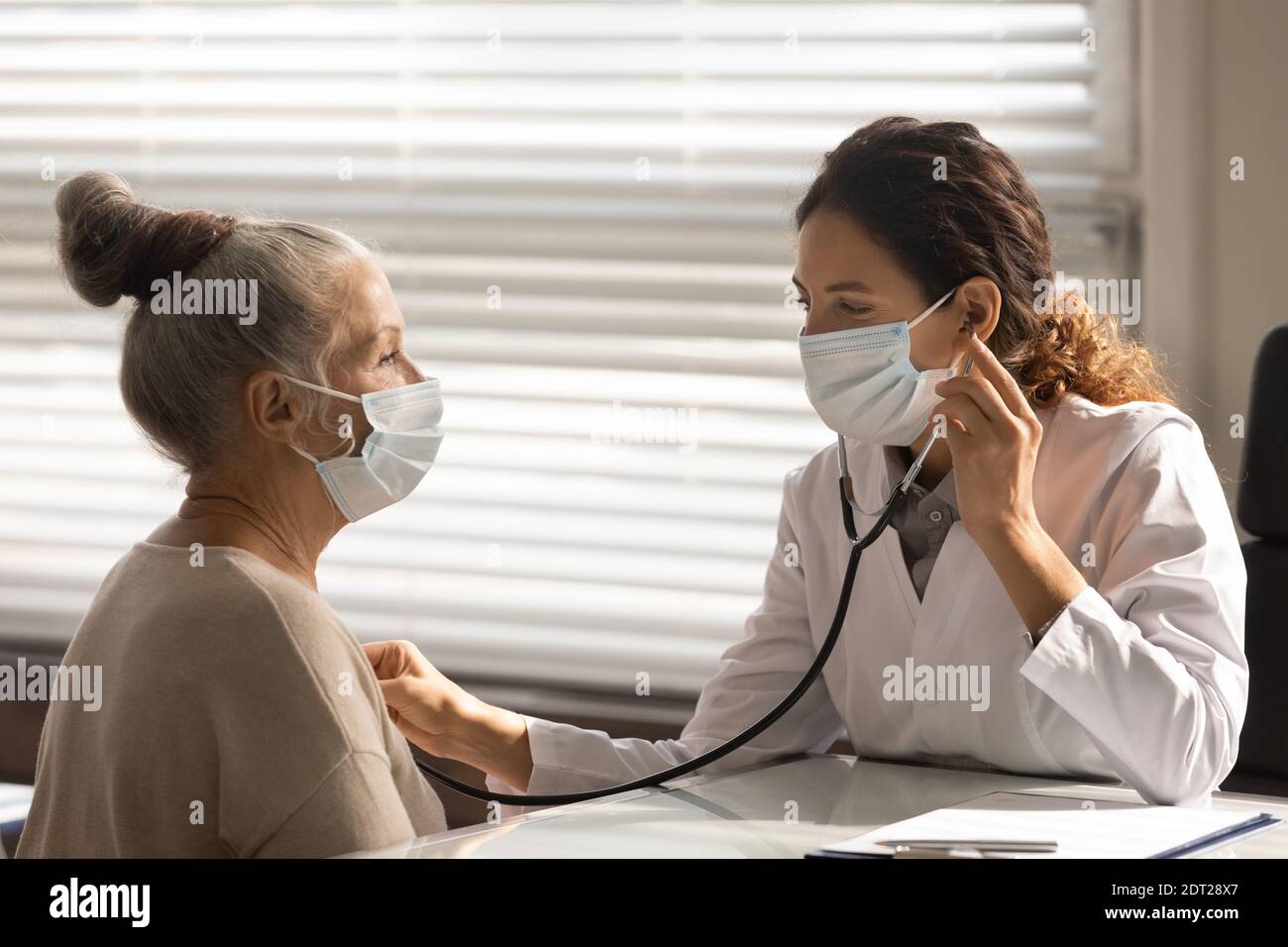 Female doctor listen to senior patient heart Stock Photo - Alamy