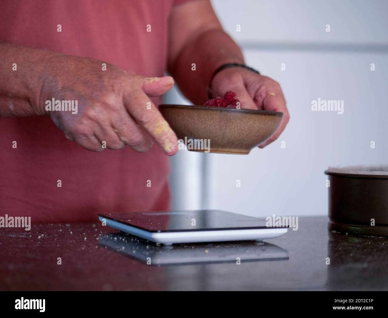 Man weighing ingredients for cake Stock Photo - Alamy