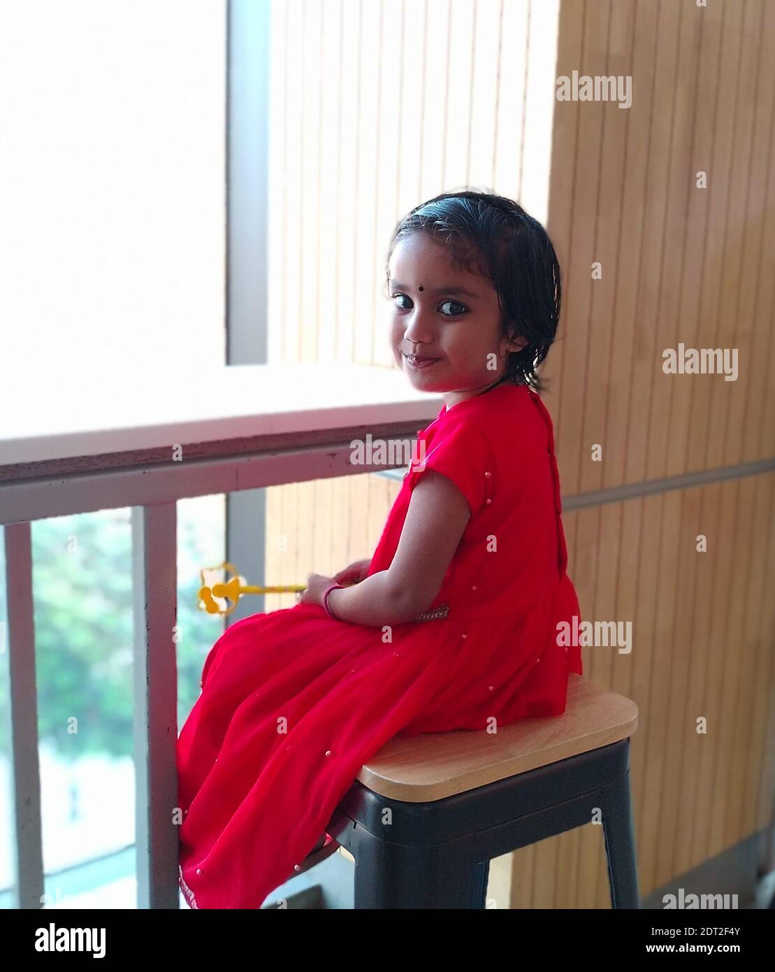 Portrait Of Girl Sitting On Seat Stock Photo - Alamy