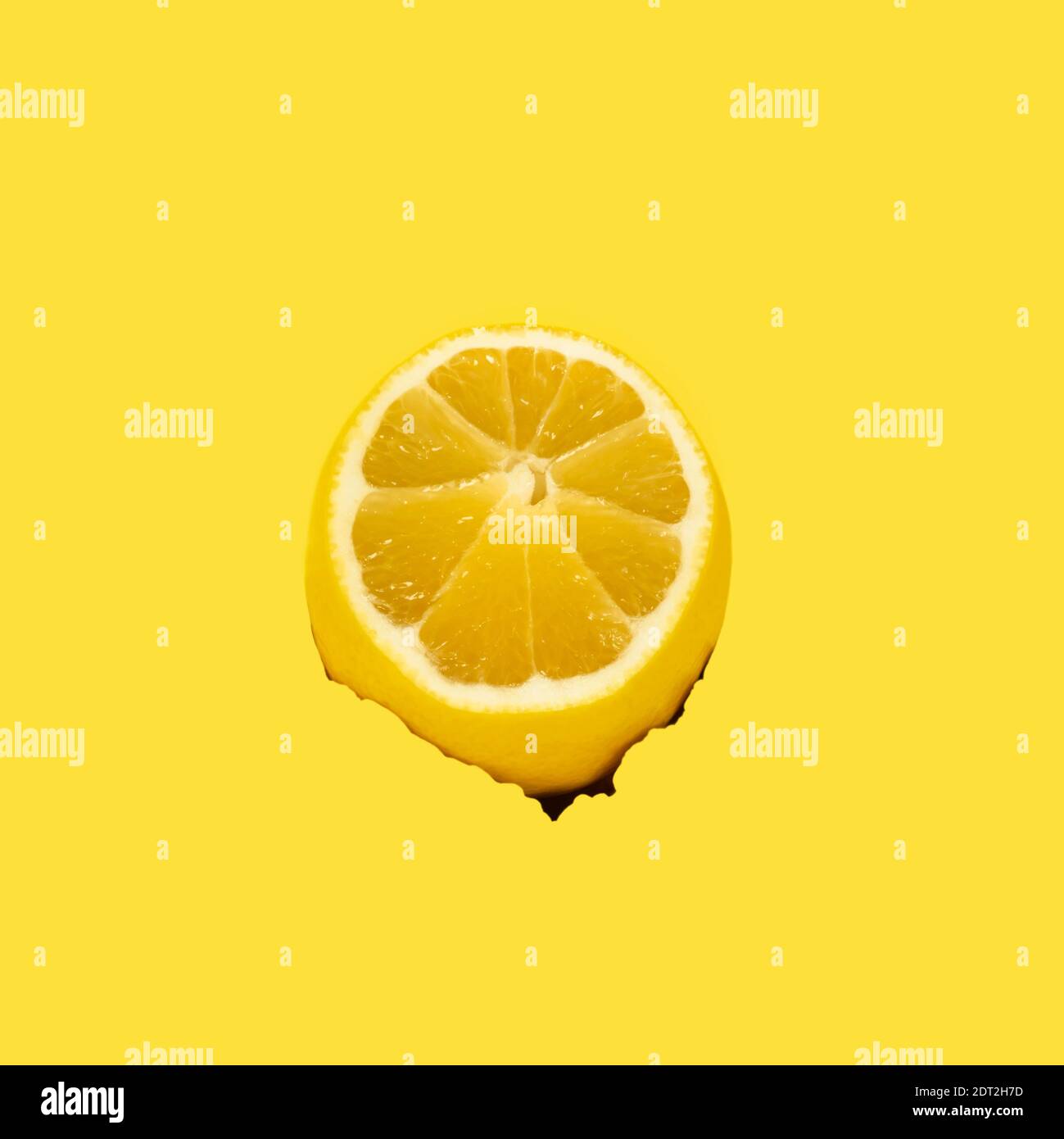 Torn hole on a yellow background and lemon as a source of vitamin C and ...