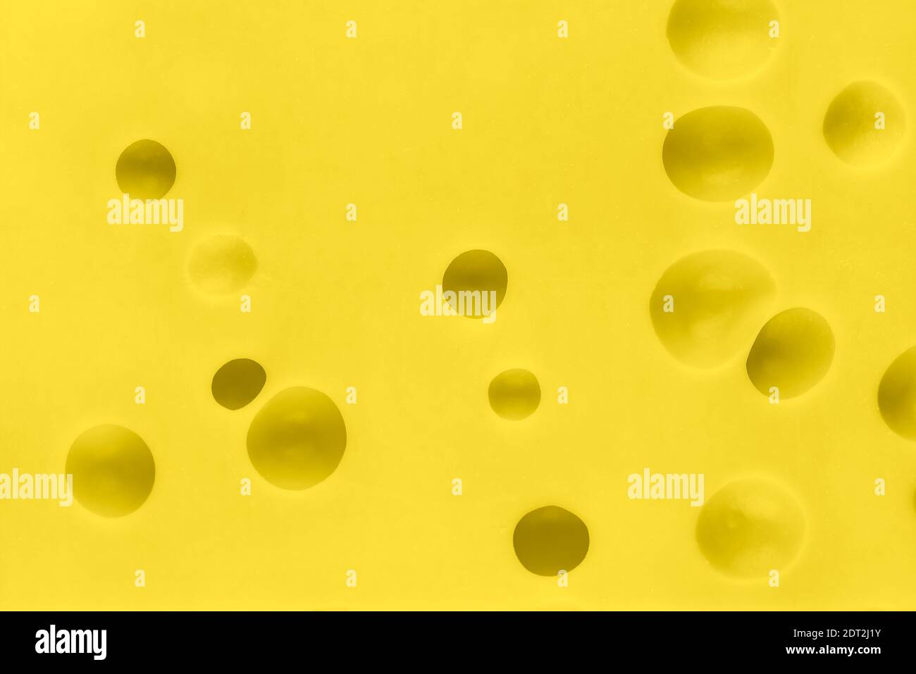 Close-up texture of yellow cheese. Cheese with big holes. Food ...