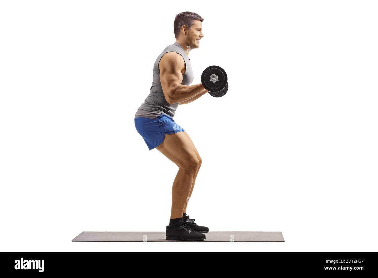 Full length profile shot of a bodybuilder lifting weights on an ...